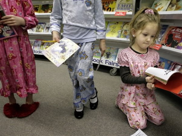 Pajama-clad reader at reading night | The Blade