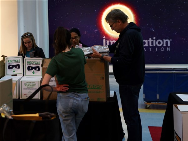 Volunteers sort eclipse glasses for reuse | The Blade